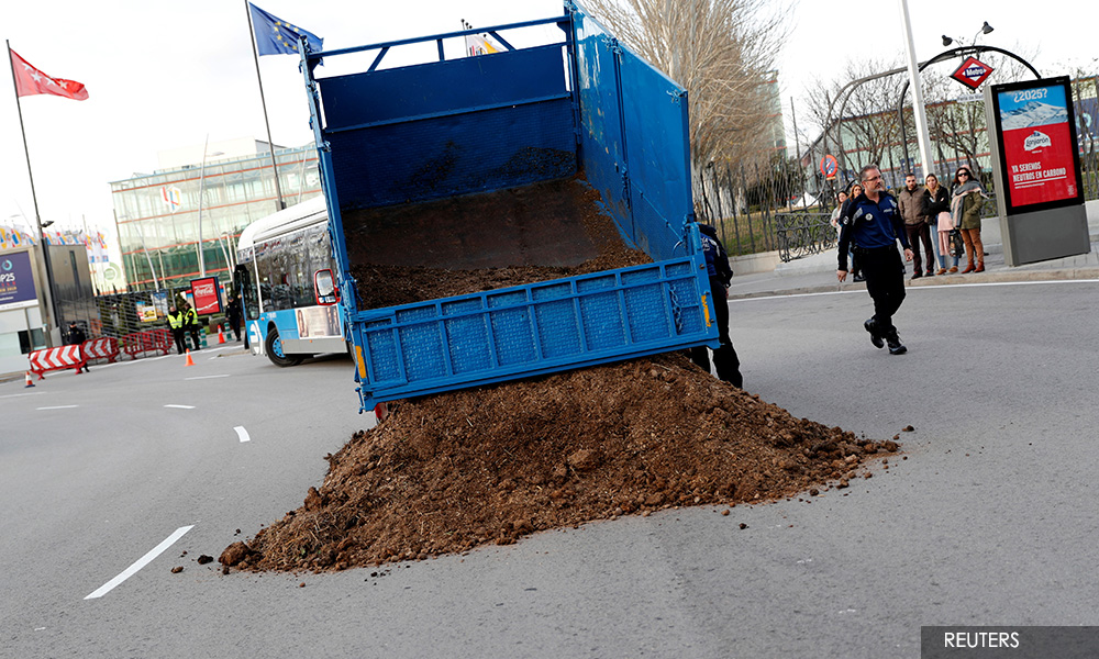 Frustrated with climate talks, activists dump manure outside Madrid summit